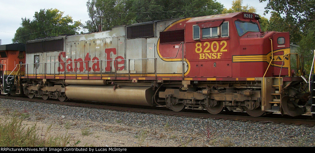 BNSF 8202 on tied down BNSF loaded grain train